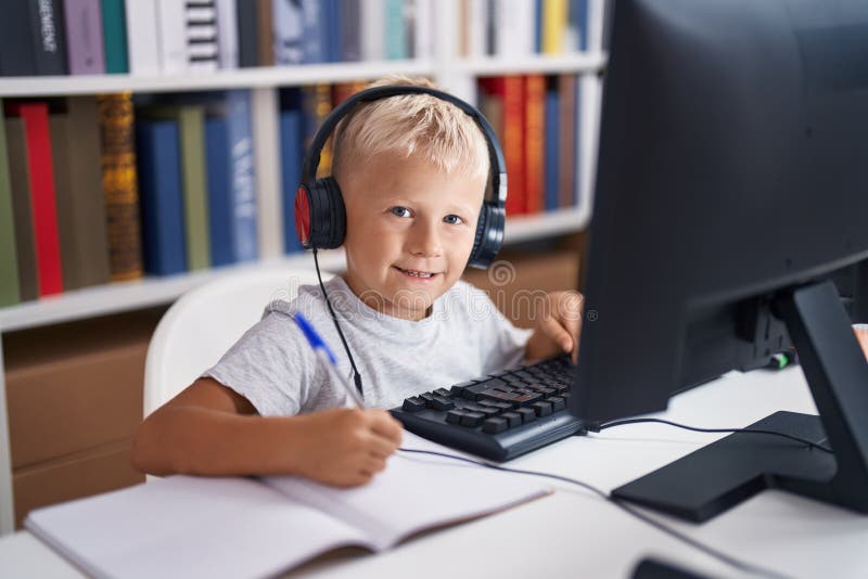 Adorable Toddler Student Using Computer Writing on Notebook at ...