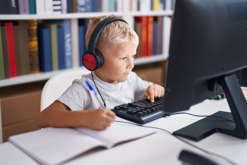Adorable Toddler Student Using Computer Writing on Notebook at ...