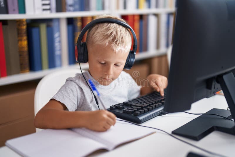 Adorable Toddler Student Using Computer Writing on Notebook at ...