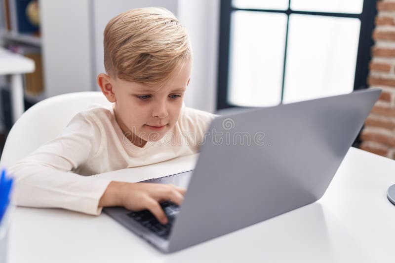 Adorable Toddler Student Using Laptop Sitting on Table at Classroom ...
