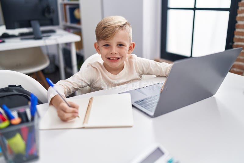 Adorable Toddler Student Using Laptop Writing on Notebook at Classroom ...