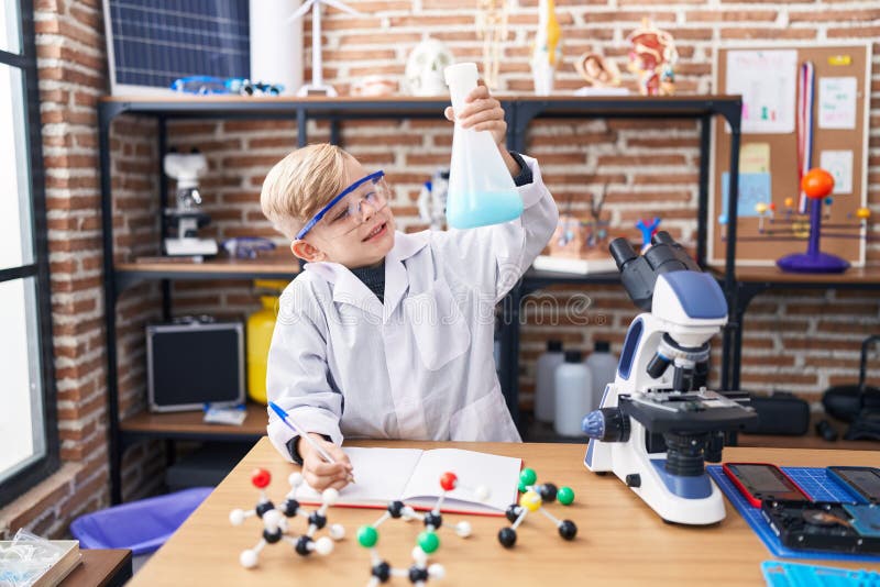 Adorable Toddler Student Writing on Notebook Holding Test Tube at ...