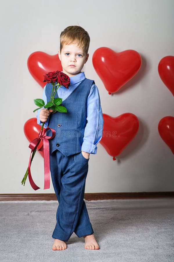 Adorable Young Boy Holding a Red Rose for Valentines Day Stock Photo ...