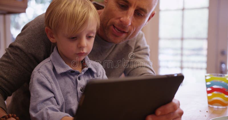 Adorable Young White Boy Learning To Use Tablet Computer Stock Photo ...