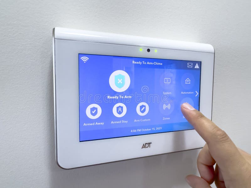 An ADT Security Panel Control on a Wall with a Person Using it ...