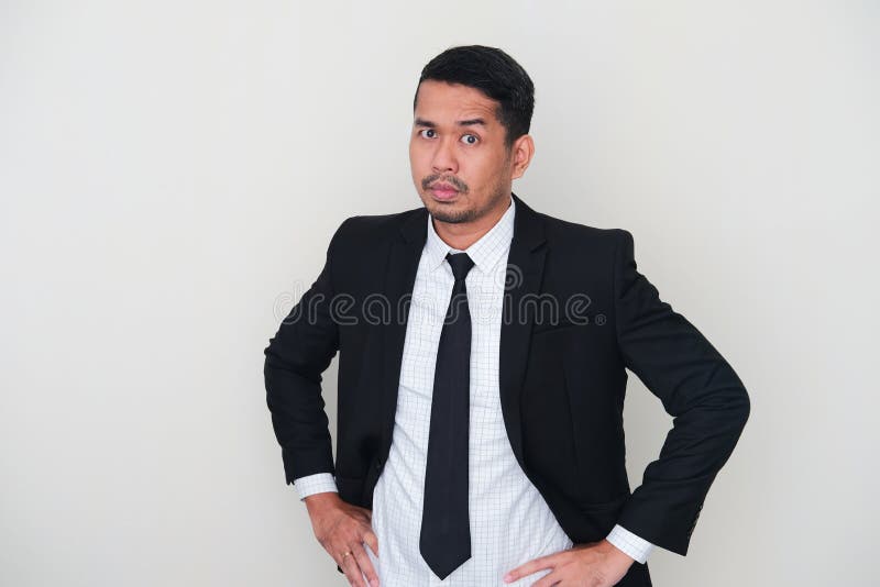 Adult Asian Man Wearing Black Suit And Tie Showing Fierce Face With His