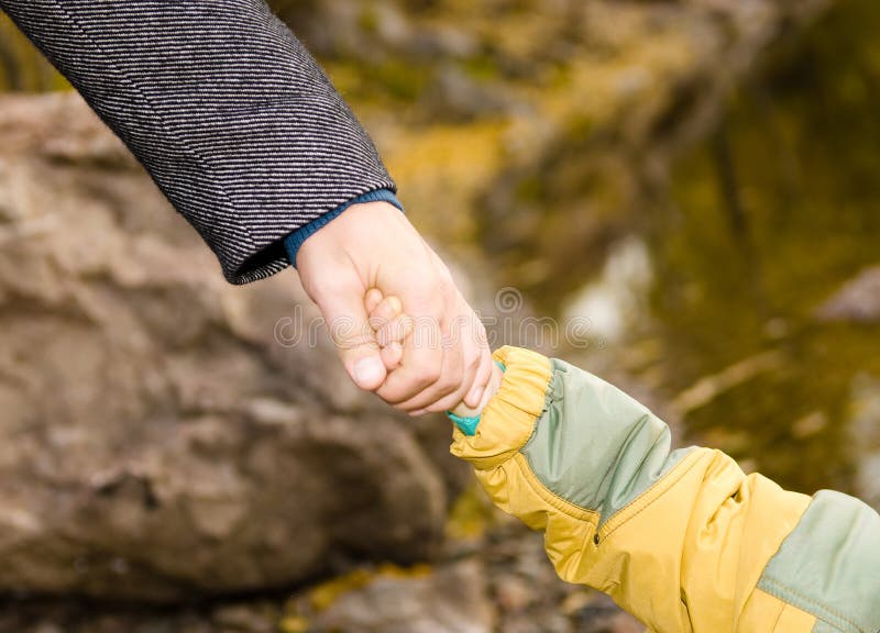Adult hand hold kid s hand stock photo. Image of friends - 16244218