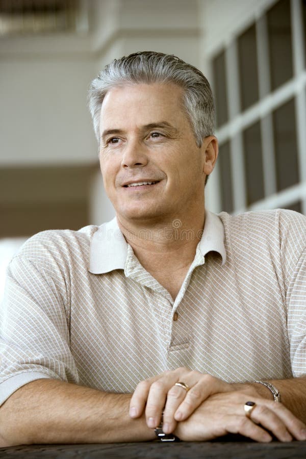 Adult Male Sitting at Table. Stock Photo - Image of color, outdoors ...