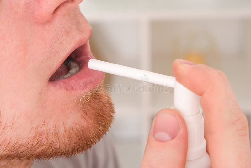 An Adult Male Uses Throat Spray To Relieve Sore Throat The Concept Of
