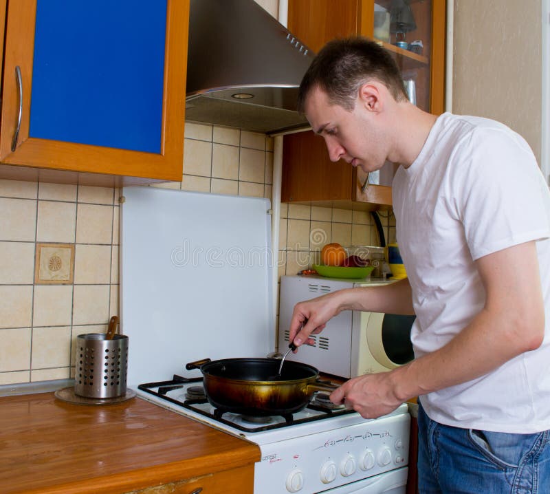 Adult Man Cooking at the Kitchen Stock Photo - Image of paprika, laughs ...