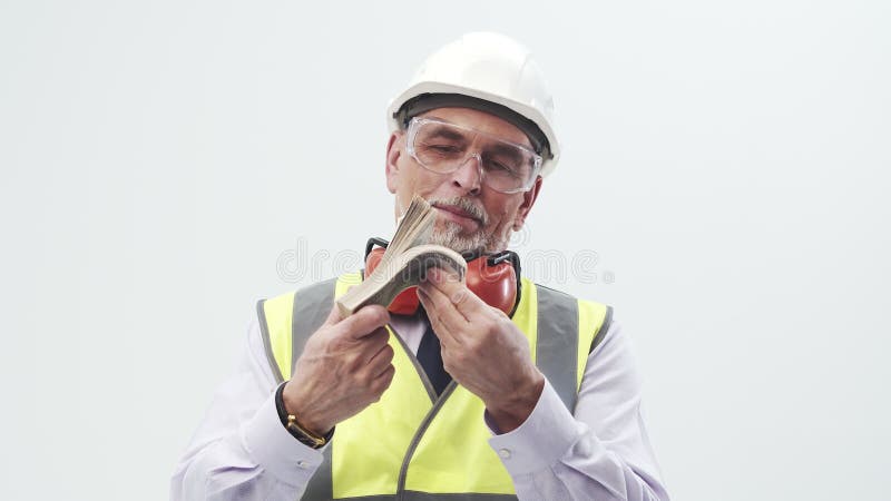 Adult Man Engineer Holds and Counts a Stack of Dollar Bills, Looking ...