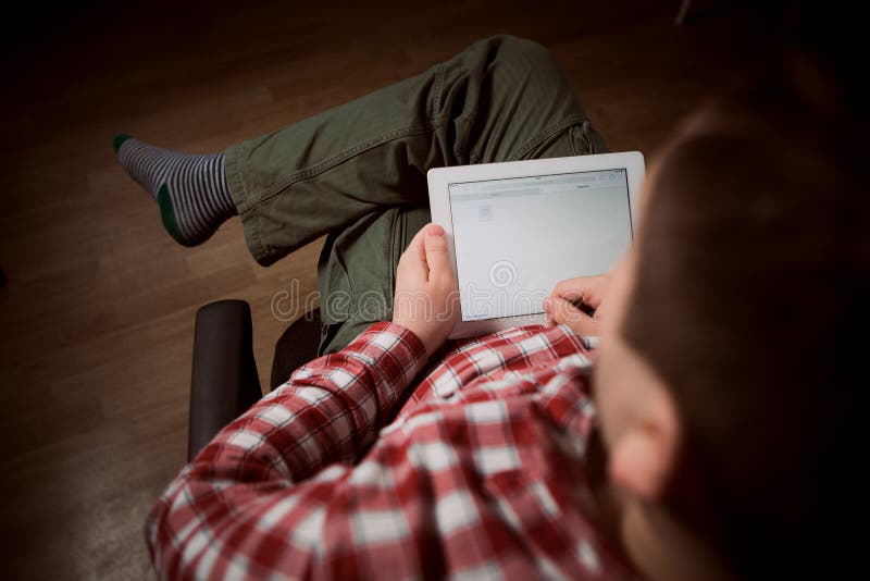 Adult man on tablet pc stock photo. Image of couch, living - 39076056