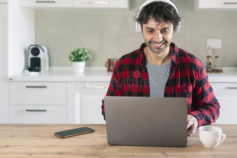Adult Man Wearing Headphones Using Laptop E-learning at Home Stock ...