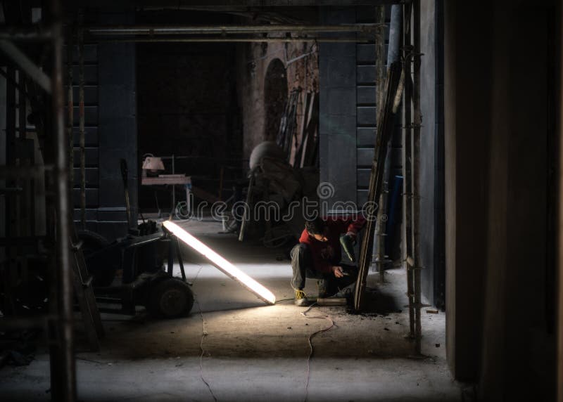 Adult Man Working on a Wooden Plank in a Dark Workshop Stock Image ...