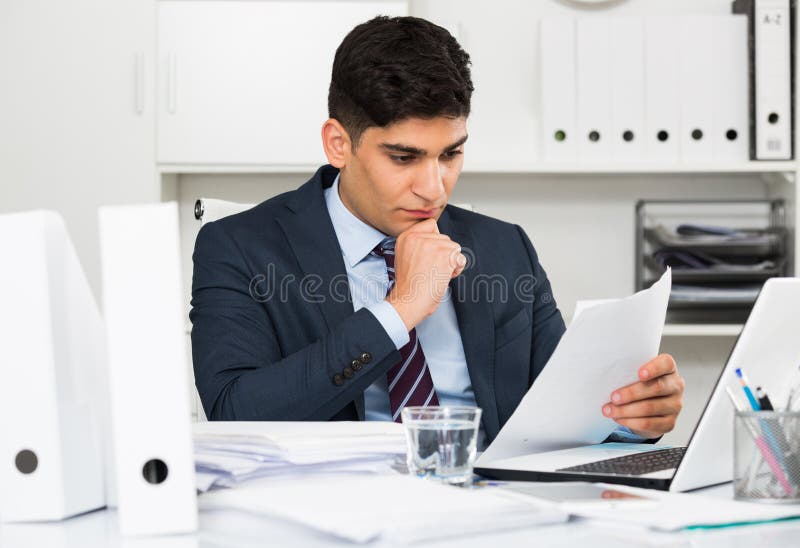 Adult Office Worker is Reading Documents about the Transaction Stock ...