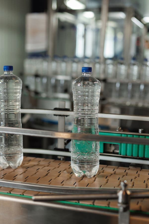 An Advanced Conveyor System Filling Empty Plastic Bottles with Freshwater Stock Photo - Image of ...
