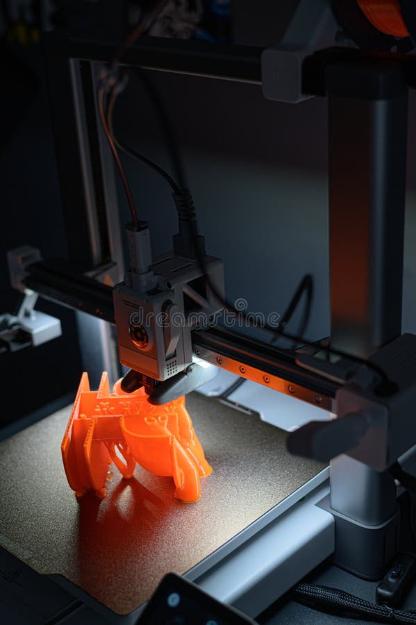 3D Printer Creating Orange Plastic Object on Platform Stock Image ...