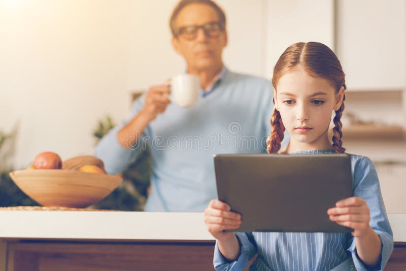 Serious Girl Using Tablet Computer at Home Stock Photo - Image of girl ...