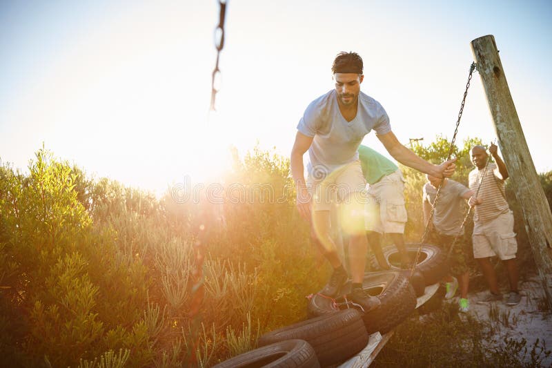 Adventure Seekers. a Group of Men Going through an Obstacle Course at ...