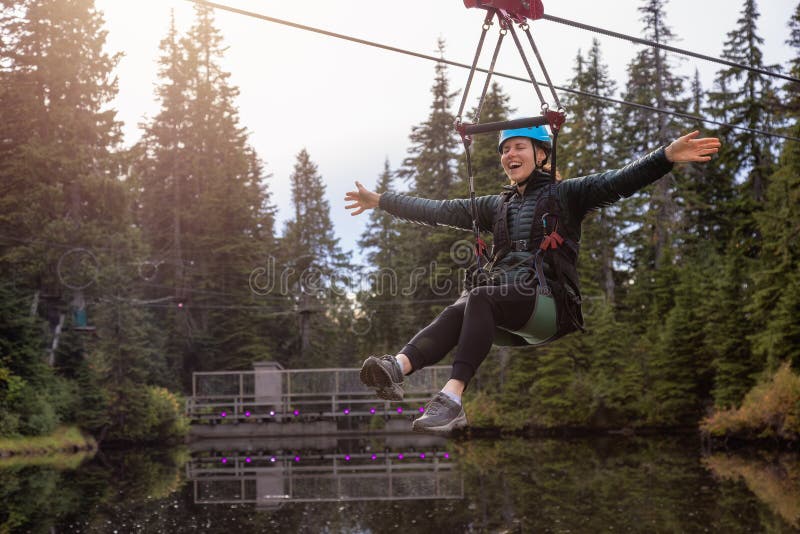Adventure Woman Riding on a Zipline. Stock Photo - Image of people ...
