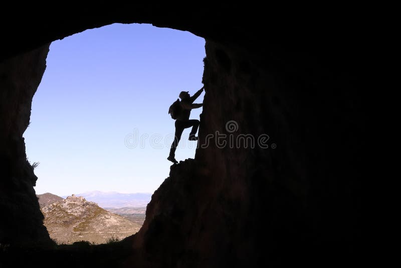 EXPLORER MAN with BACKPACK CLIMBING in a CAVE with a CASTLE at SIGHT ...