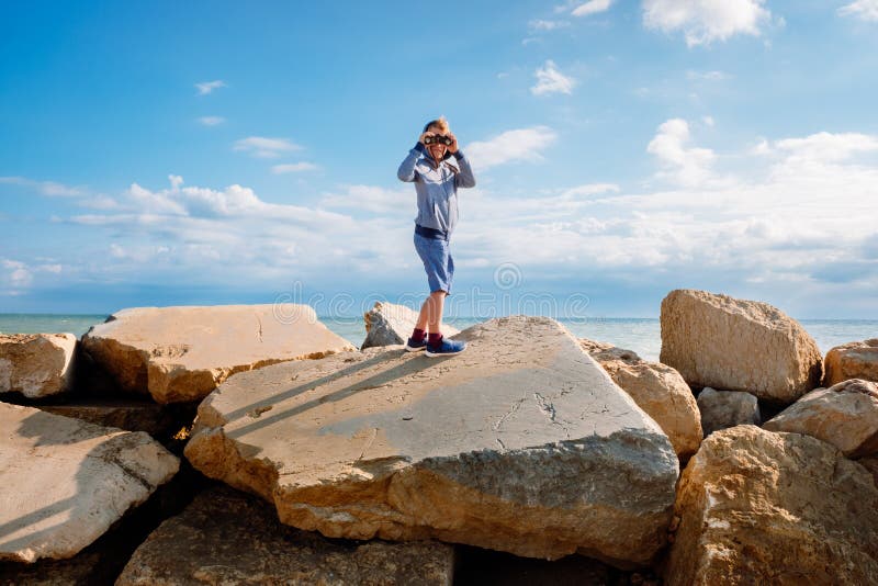 An Adventurous Boy Explores the Landscape with Binoculars with the ...