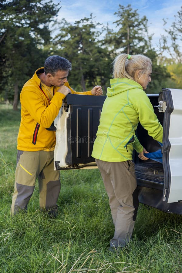 Adventurous Couple Setting Up Camp Outdoors Stock Photo - Image of ...