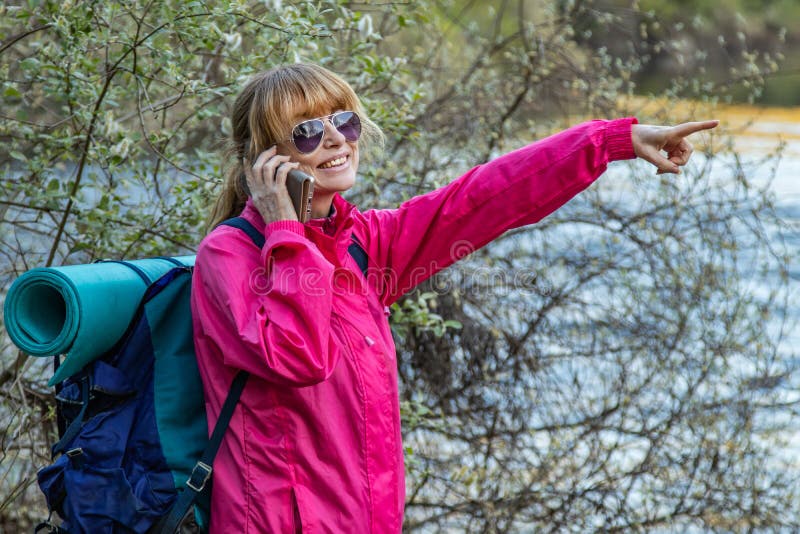 Woman with Backpack Talking on Mobile Phone Stock Image - Image of ...