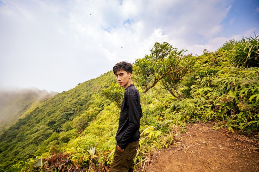 Adventurous Man Facing Camera on Top of Mountain. Spectacular Mountain ...