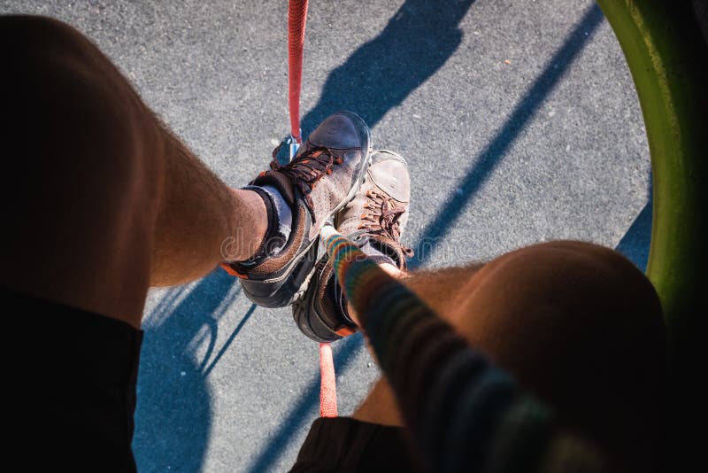Adventurous Man Slides Down a Rope, Seen from His Boots Stock Image ...