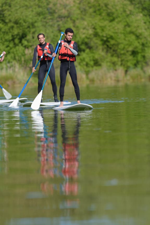 Adventurous Men Learning To Paddle on Stand Up Board Stock Photo ...