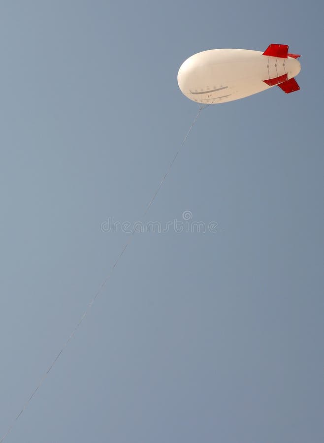Red blimp in blue sky stock image. Image of aircraft, floating - 997237