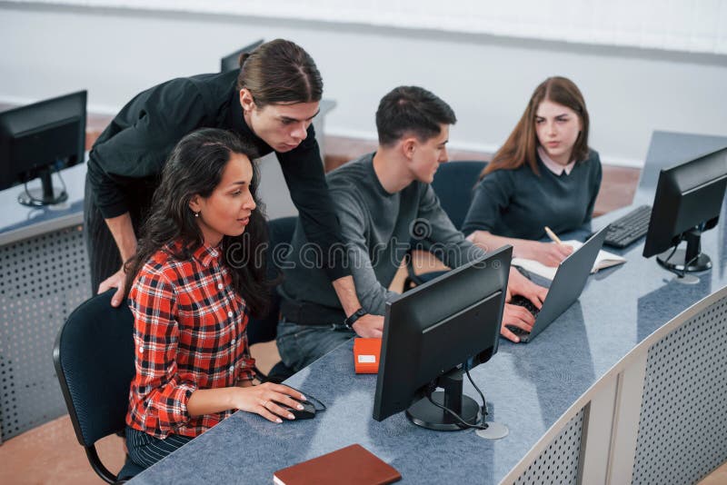 Advice Needed from You. Group of Young People in Casual Clothes Working ...