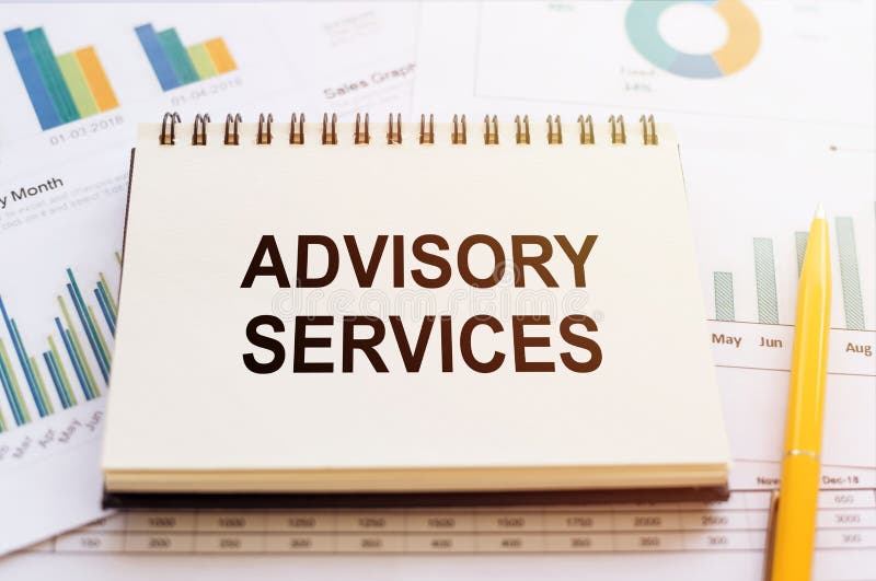 ADVISORY SERVICES - Written on Notepad on Financial Charts and Graphs ...