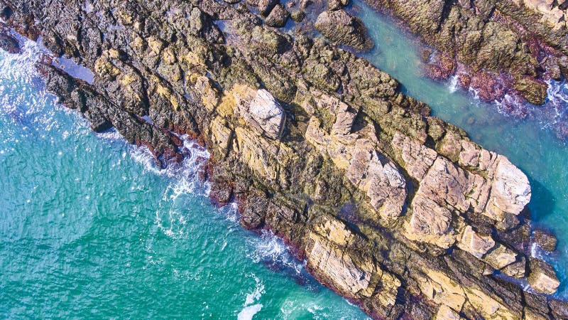 Aerial Down of Rocky Coast Section with Crashing Waves Stock Photo ...