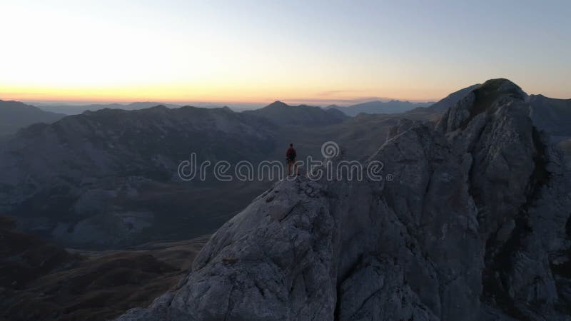Aerial Epic Shot of a Man Standing on the Edge of the Mountain Stock ...