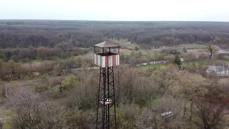 AERIAL. Flying Around the Observation Tower Overlooking the Village ...