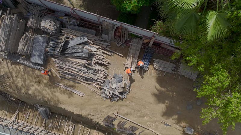 Aerial View: Workers Insulate Foundations and Manage Metal Structures ...