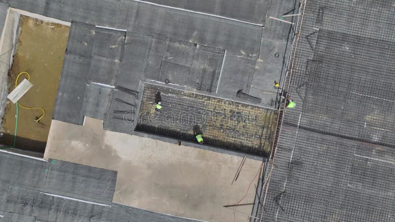 Aerial View: Workers Apply Insulation To Foundations and Assemble Metal ...