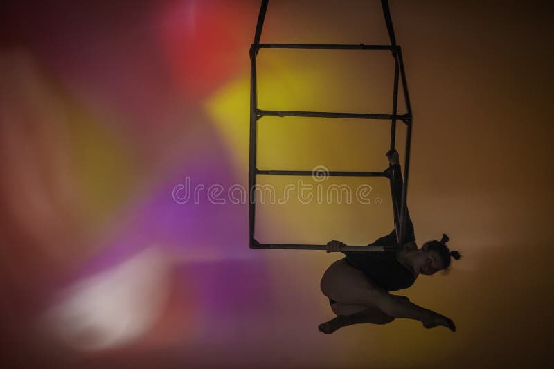 Aerial Gymnast in Black Leotard on Multicolored Background of Studio ...
