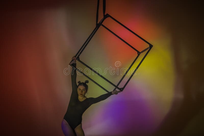 Aerial Gymnast in Black Leotard on Multicolored Background of Studio ...