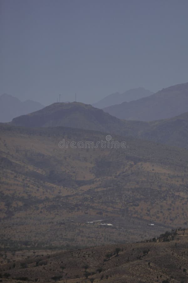 Aerial Image Features a Large Open Plain with a Range of Mountains in ...