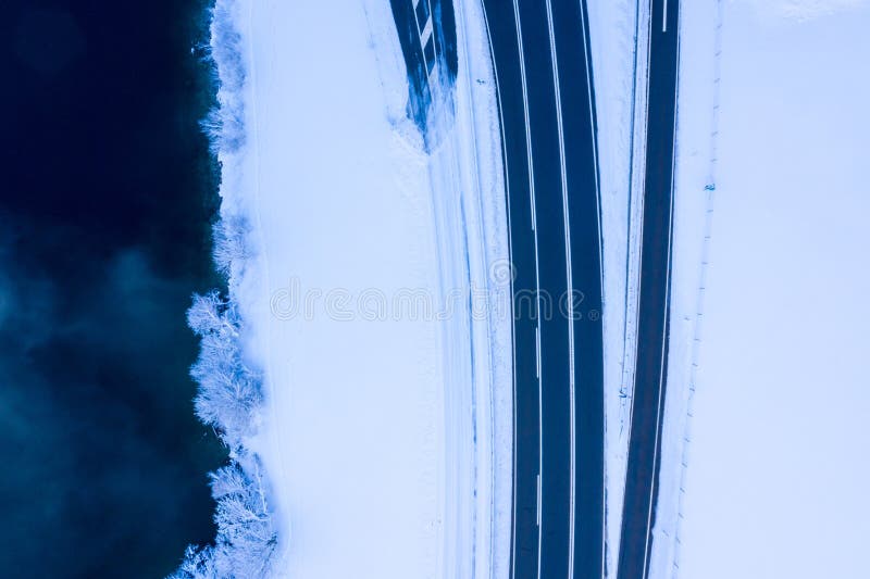 Aerial Overhead Shot of Empty Roads Surrounded by Snow and Trees Stock ...