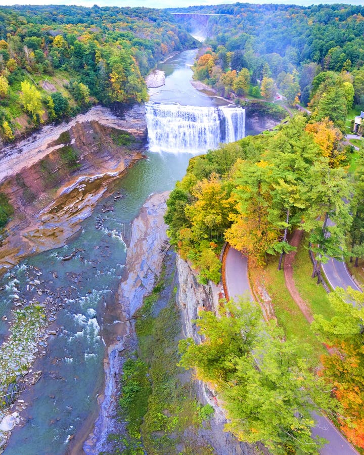 Aerial Panorama Over Road Along Edge of Cliffs with Raging Waterfall ...