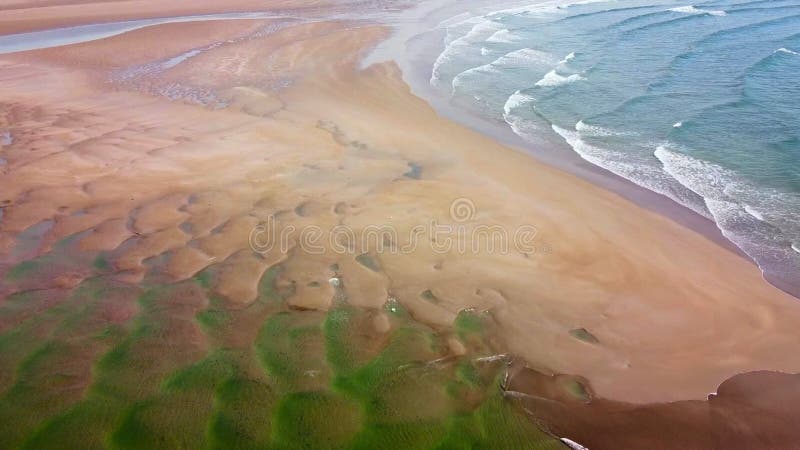 An Aerial Perspective Captures Waves Breaking Along the Sandy Shoreline ...