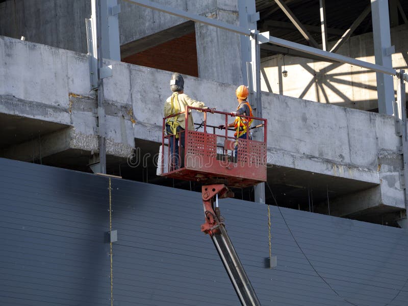 An Aerial Platform Lifts Workers To the Upper Floors of a Building ...