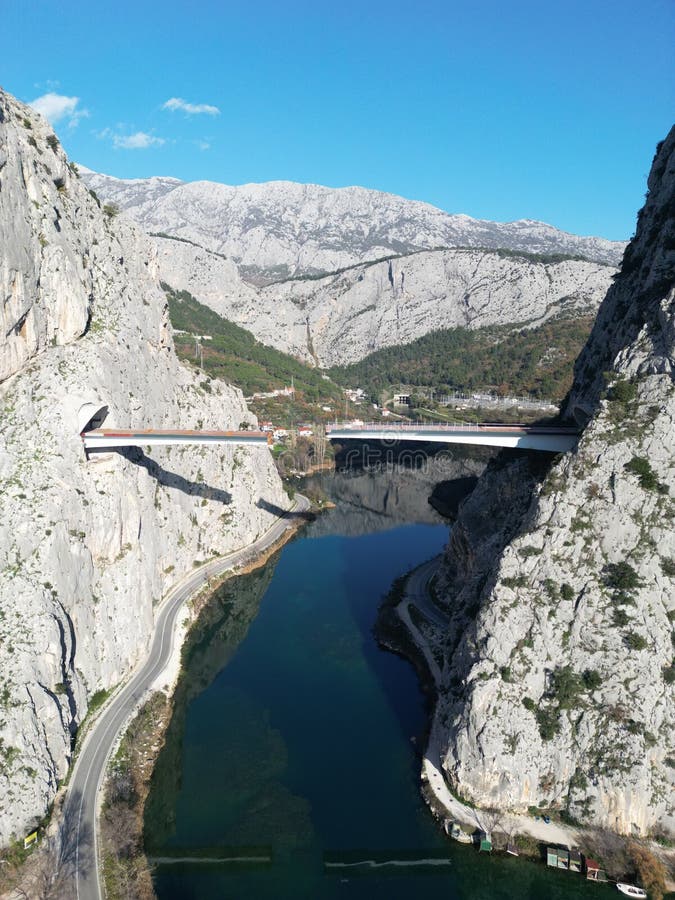 Aerial Shot of a Bridge with an Asphalt Road Connecting Two Cliffs in ...