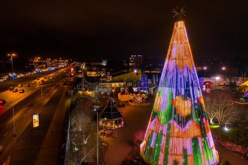 Aerial Shot of a Cityscape at Night with a Lit Christmas Tree Stock ...