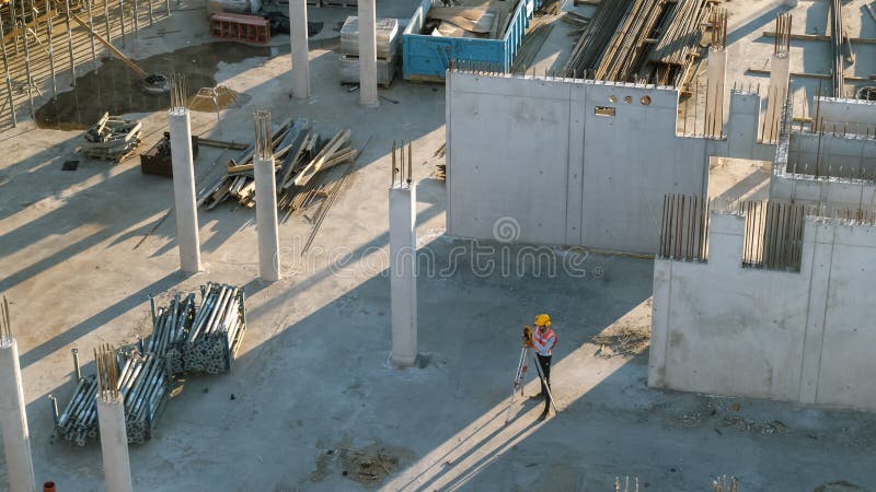 Aerial Shot of a Construction Worker Using Theodolite Surveying Optical ...