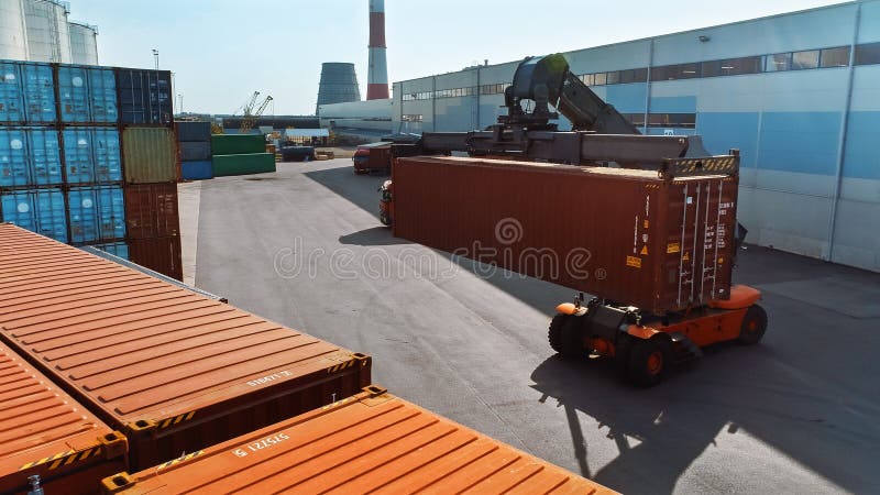 Aerial Shot of a Container Handler Carrying a Large Red Shipping Cargo ...